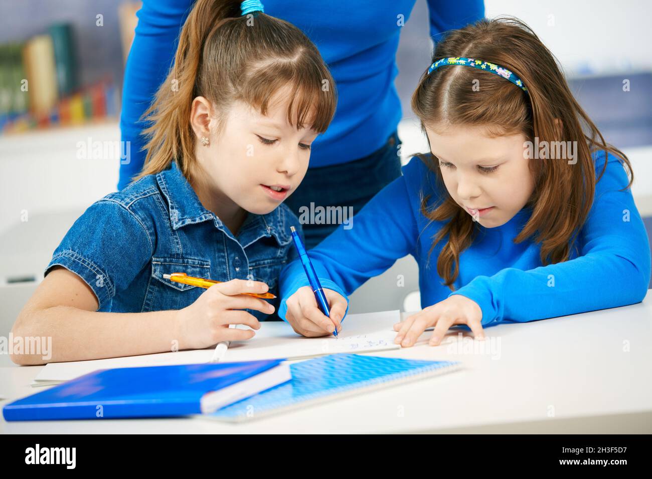 Schoolgirls learning in classroom Stock Photo - Alamy