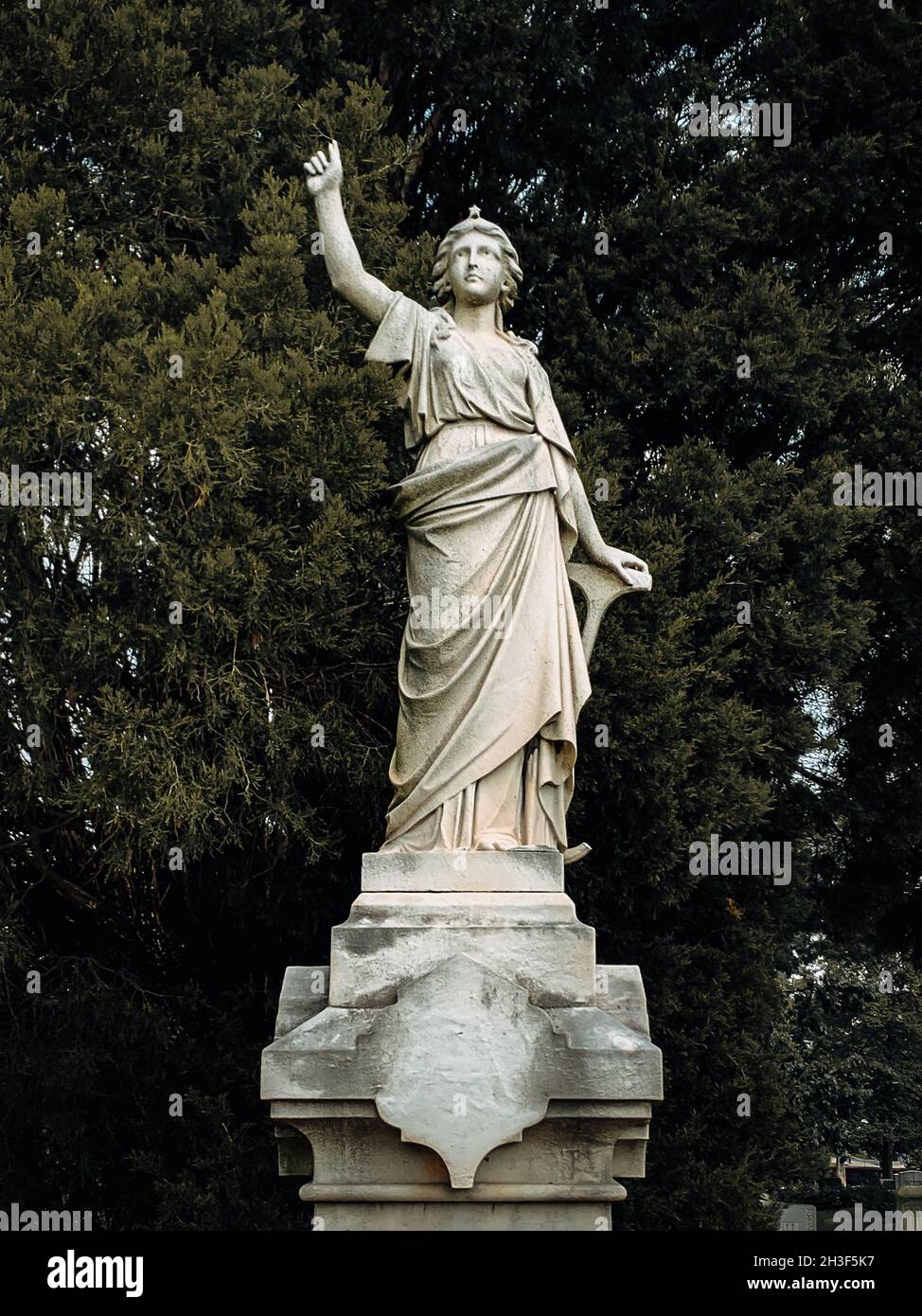 Vertical shot of a statue of a woman holding an anchor at the historic ...