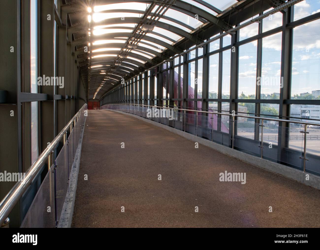 long empty road crossing with transparent glass walls. High quality ...