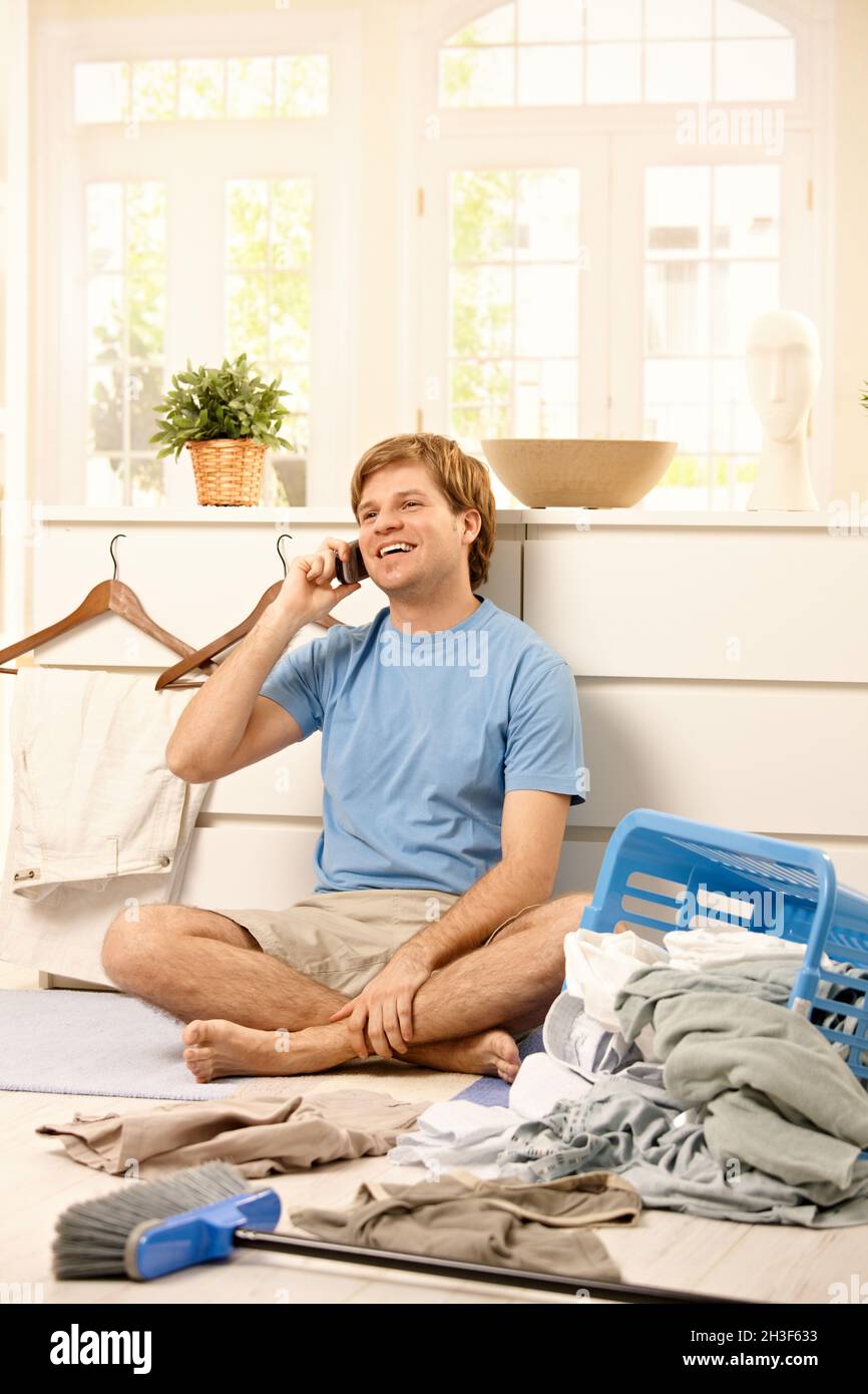 Lazy guy with mobile phone Stock Photo - Alamy