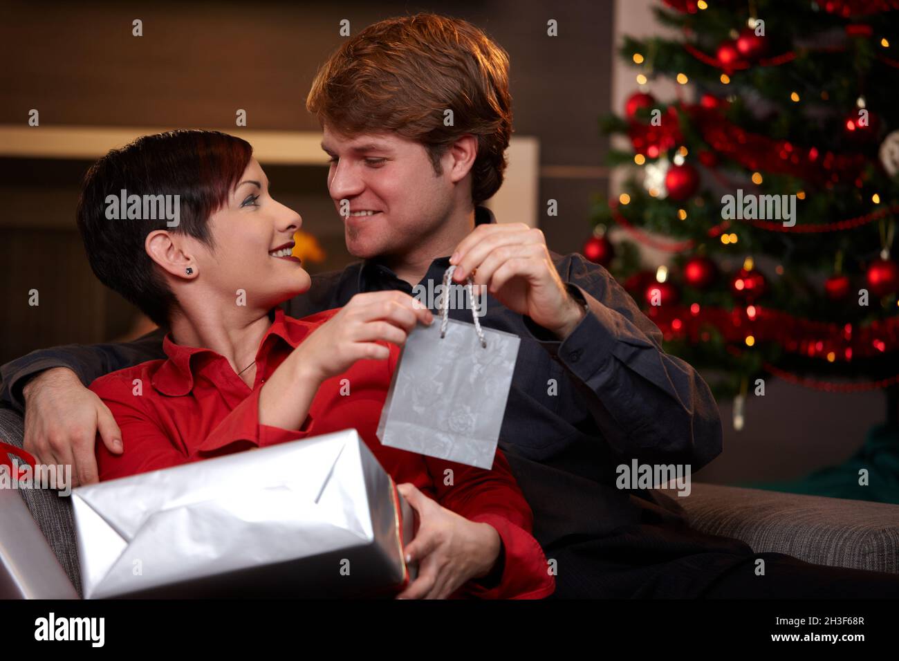 Happy man giving christmas present Stock Photo - Alamy
