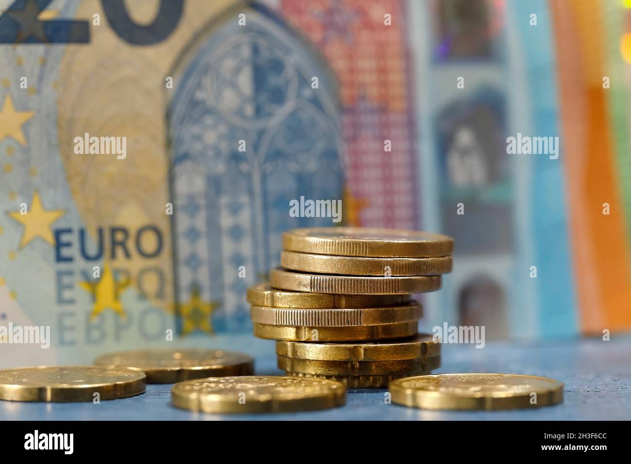 The banknote is in the background of the coins. The currency of the ...