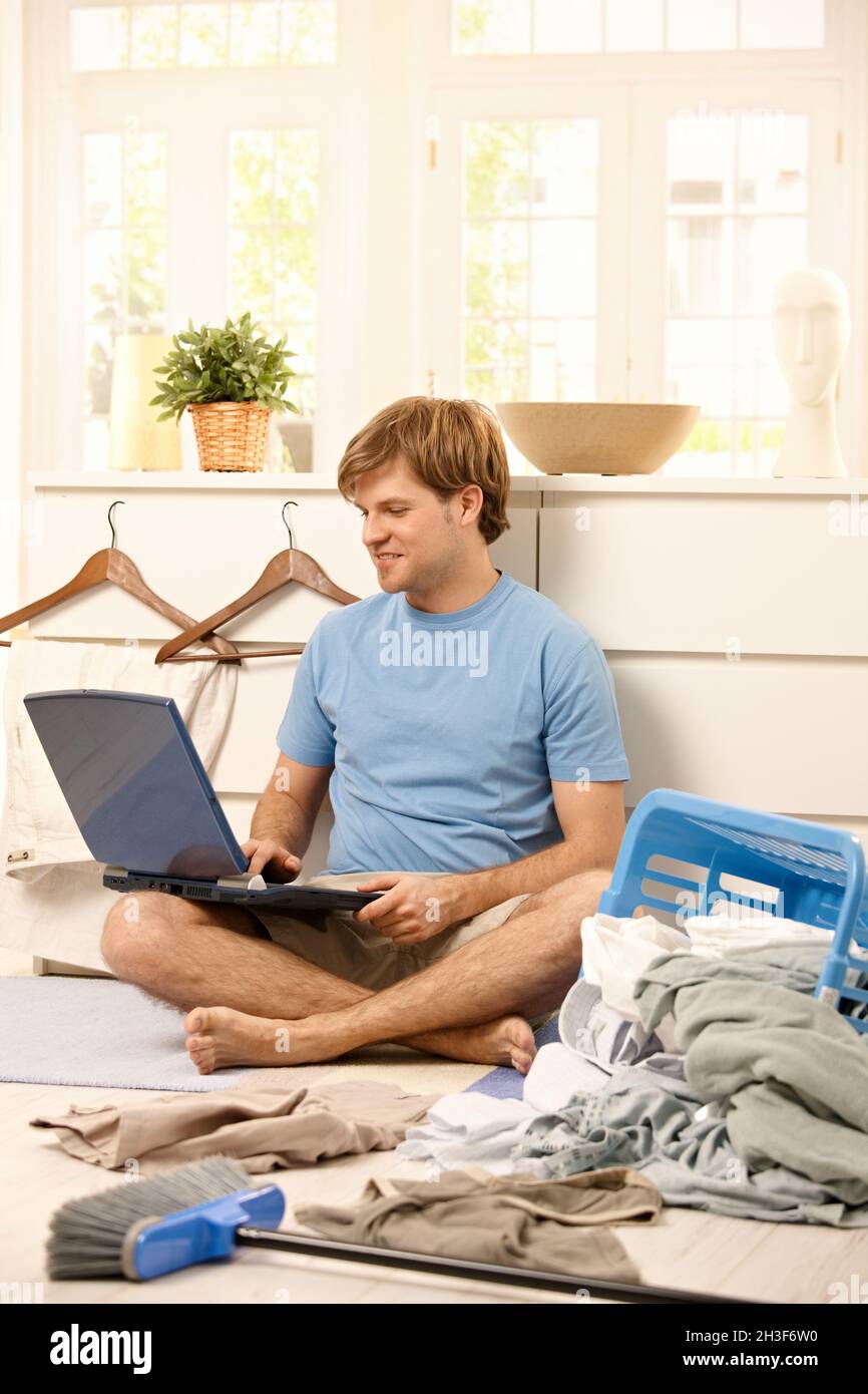 Lazy man with laptop Stock Photo - Alamy