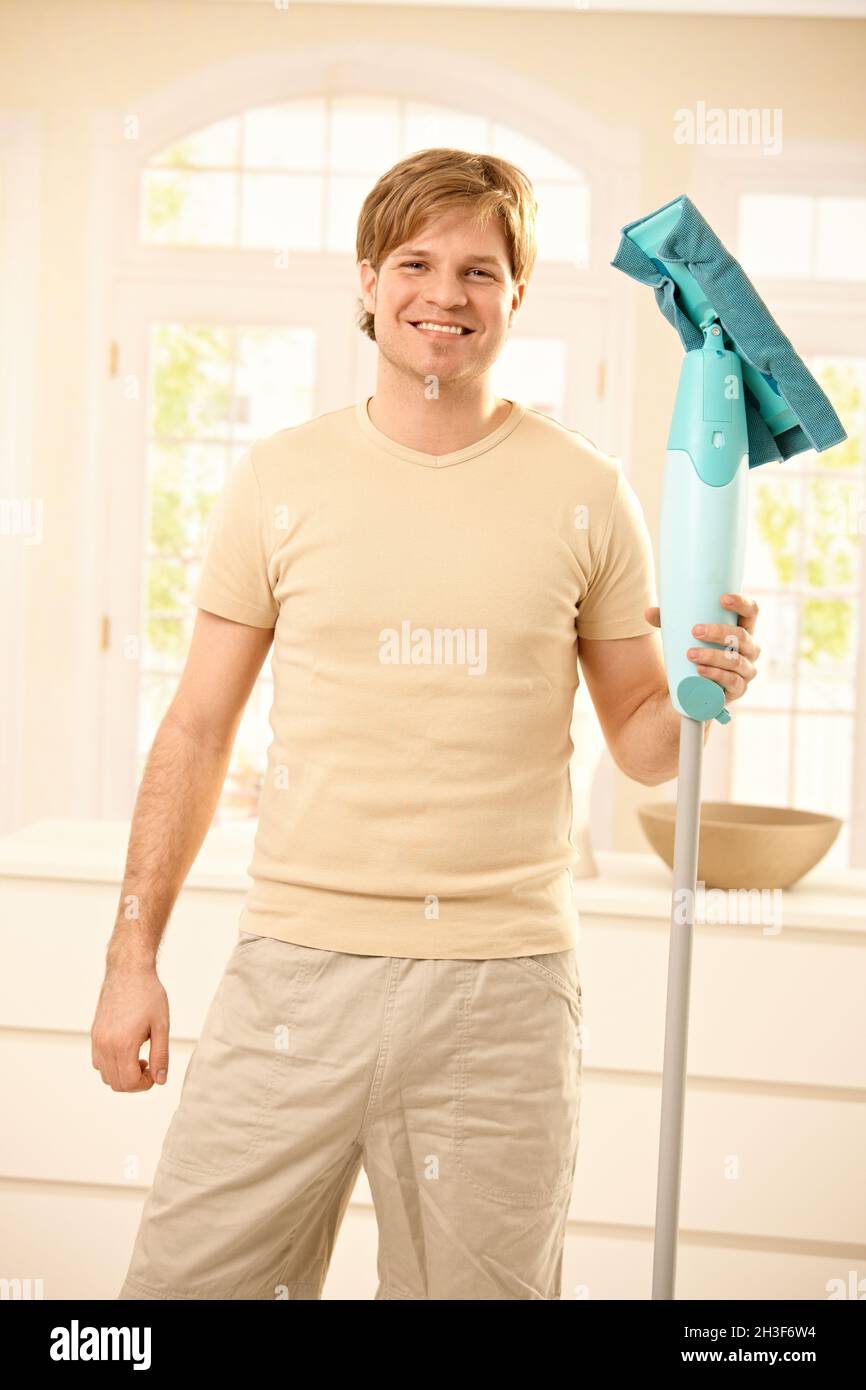 Guy posing with mop Stock Photo - Alamy
