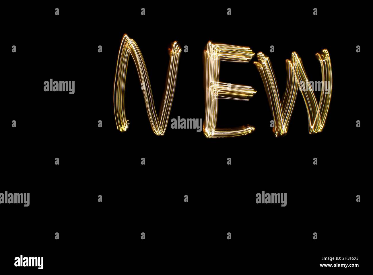 The word 'new' written against black background with long exposure ...