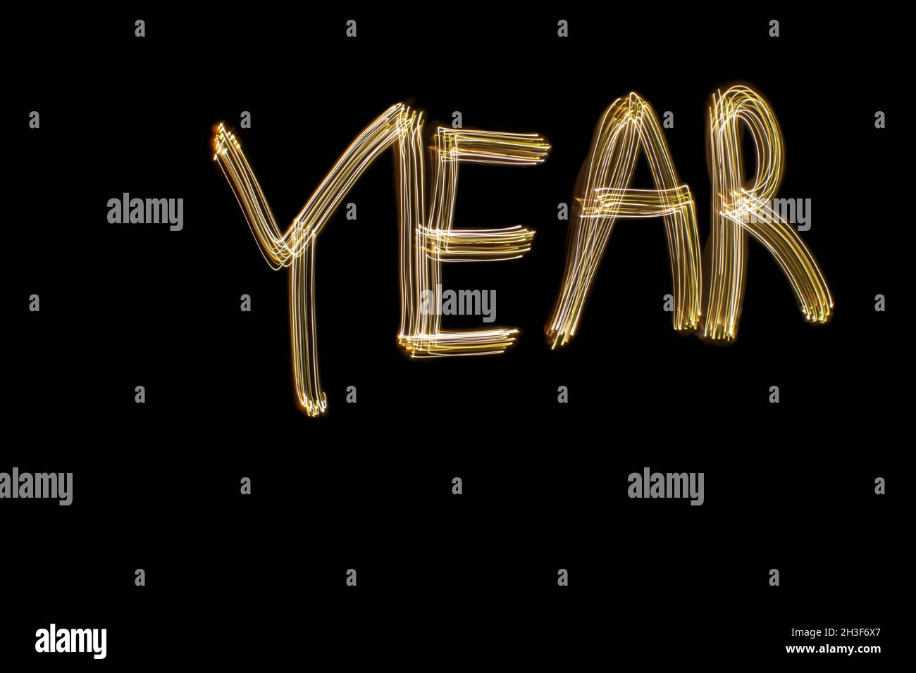 The word 'year' written against black background with long exposure ...