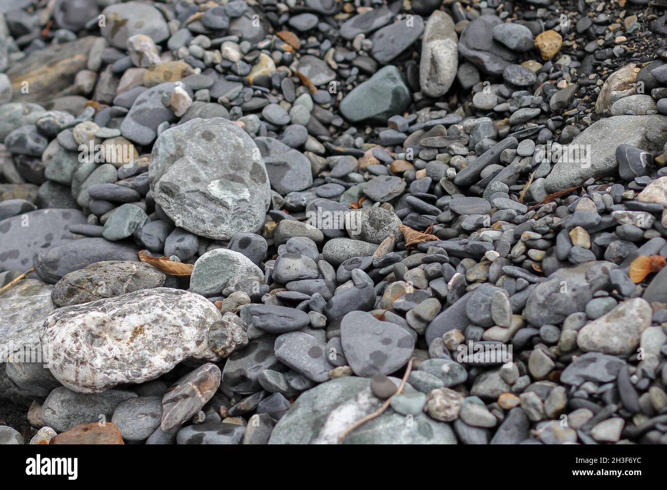 Different size stones on land of the river beach Stock Photo - Alamy