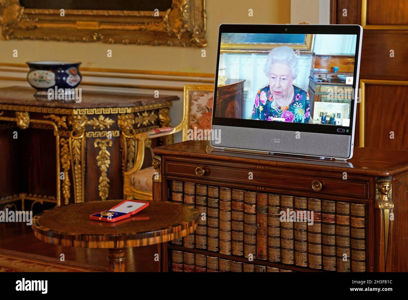 Queen Elizabeth II appears on a screen via videolink from Windsor ...