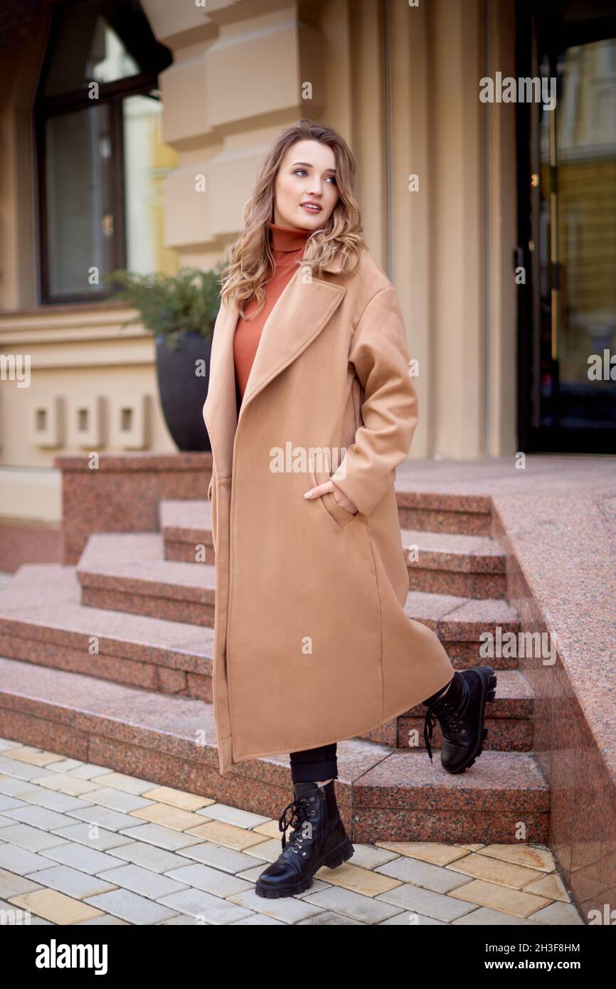 young well-groomed woman came out happy from the beauty salon after ...