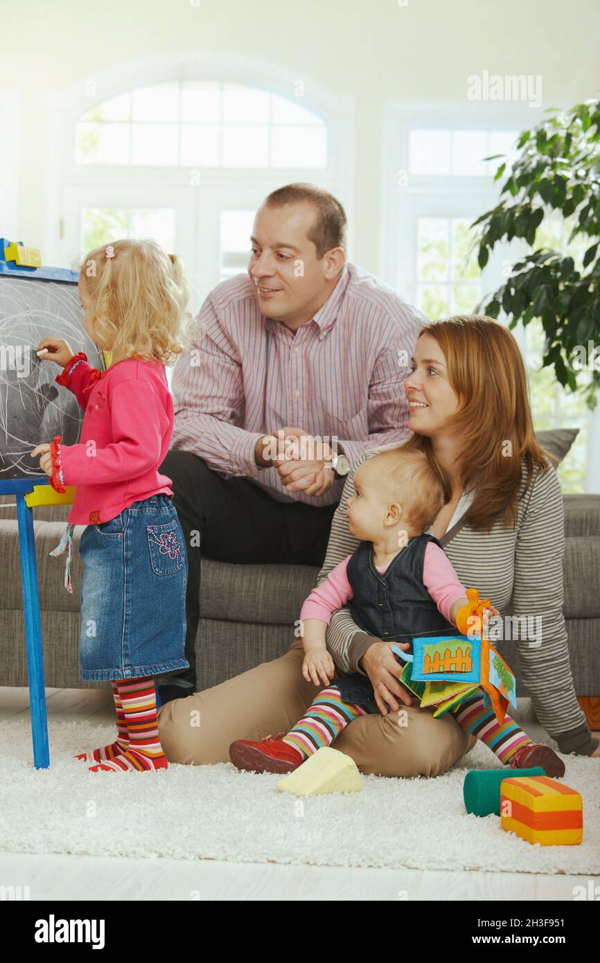 Family looking at baby girl Stock Photo - Alamy