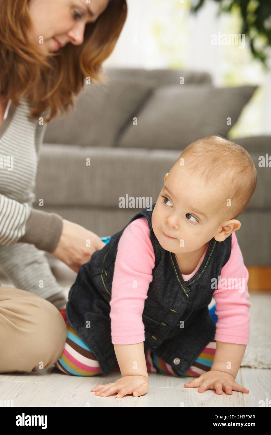 Baby girl crawling Stock Photo - Alamy