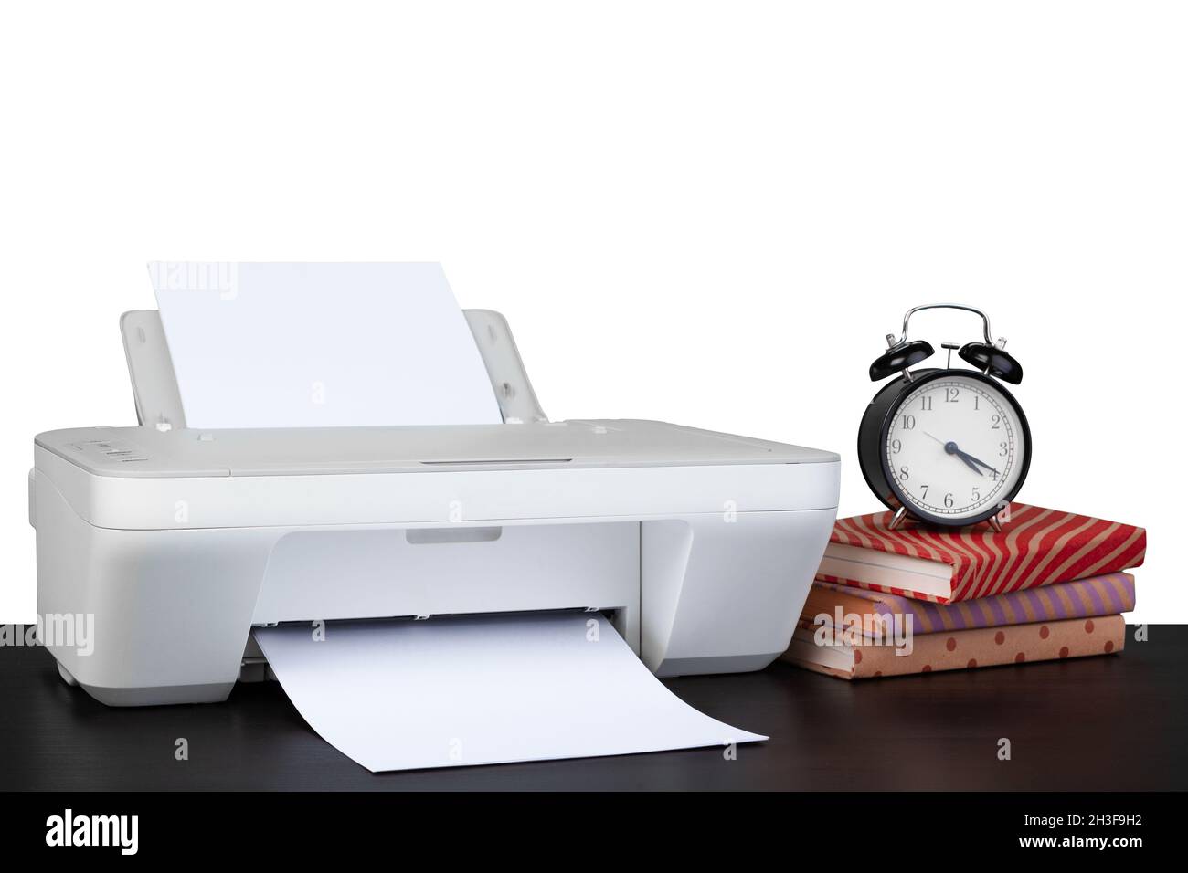 Printer and stack of books on black table against white background ...