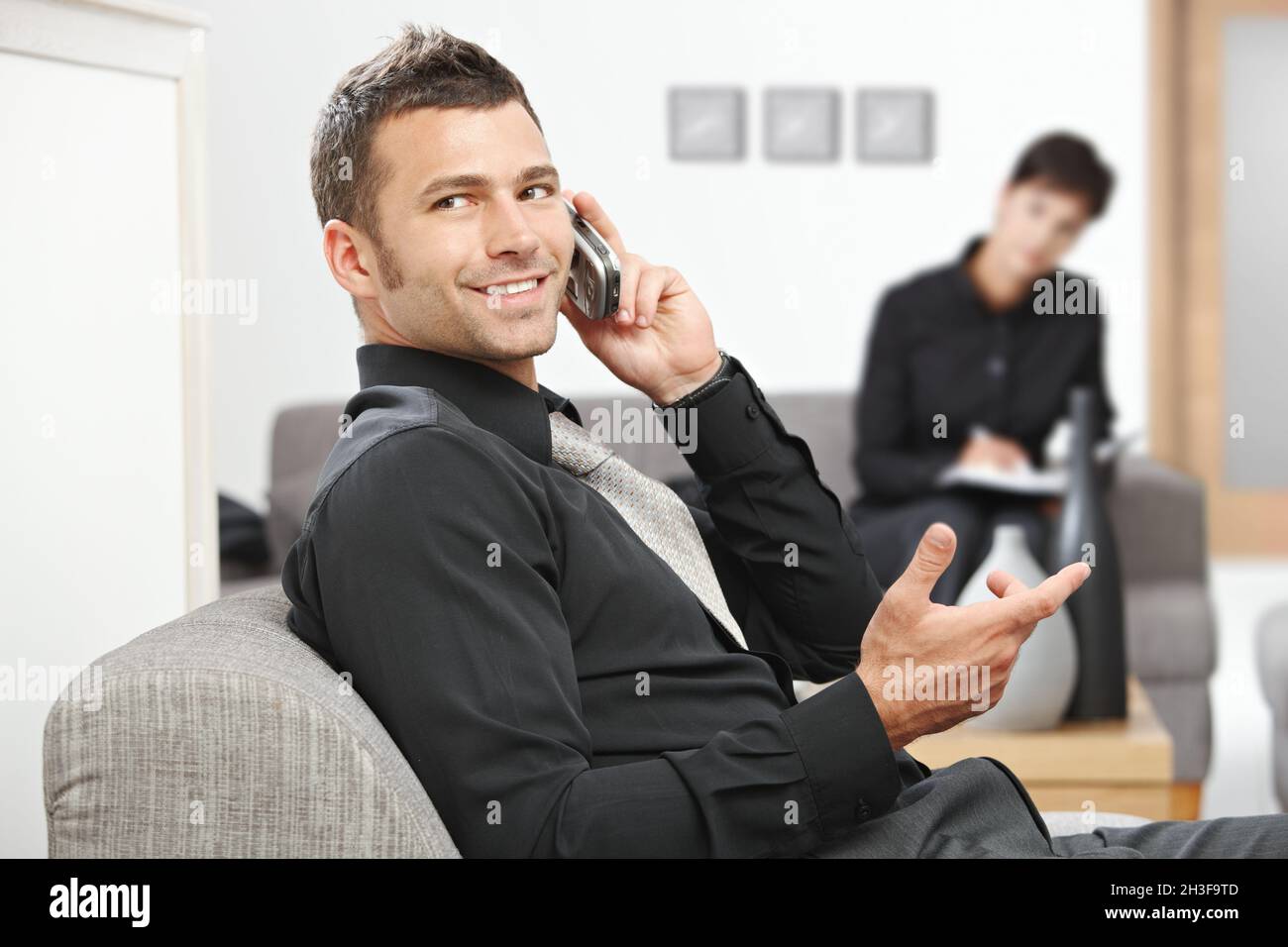 Positive corporate worker calling mobile hi-res stock photography and ...