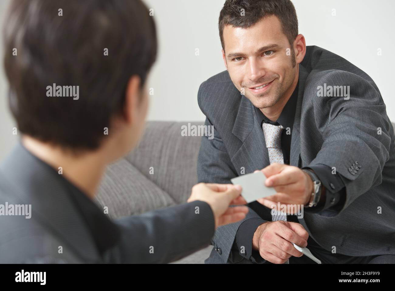 Business people changing cards Stock Photo - Alamy