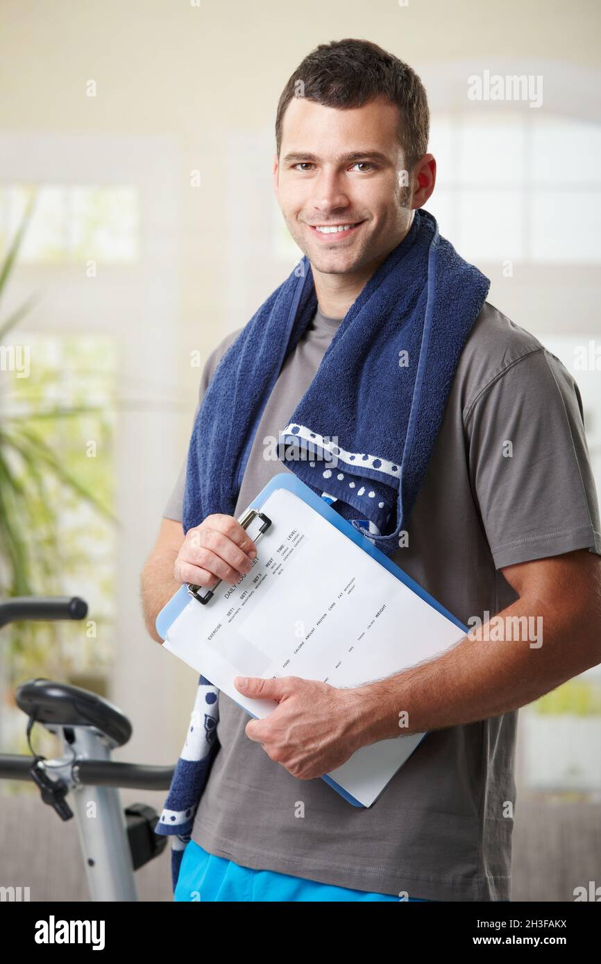 Personal trainer with training plan Stock Photo - Alamy