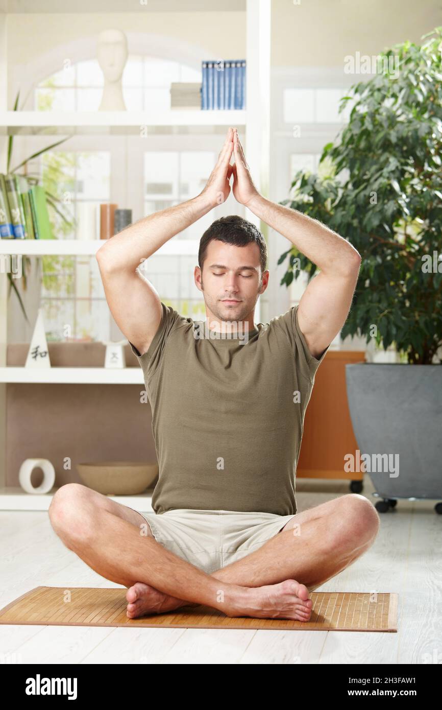Man doing yoga exercise Stock Photo - Alamy