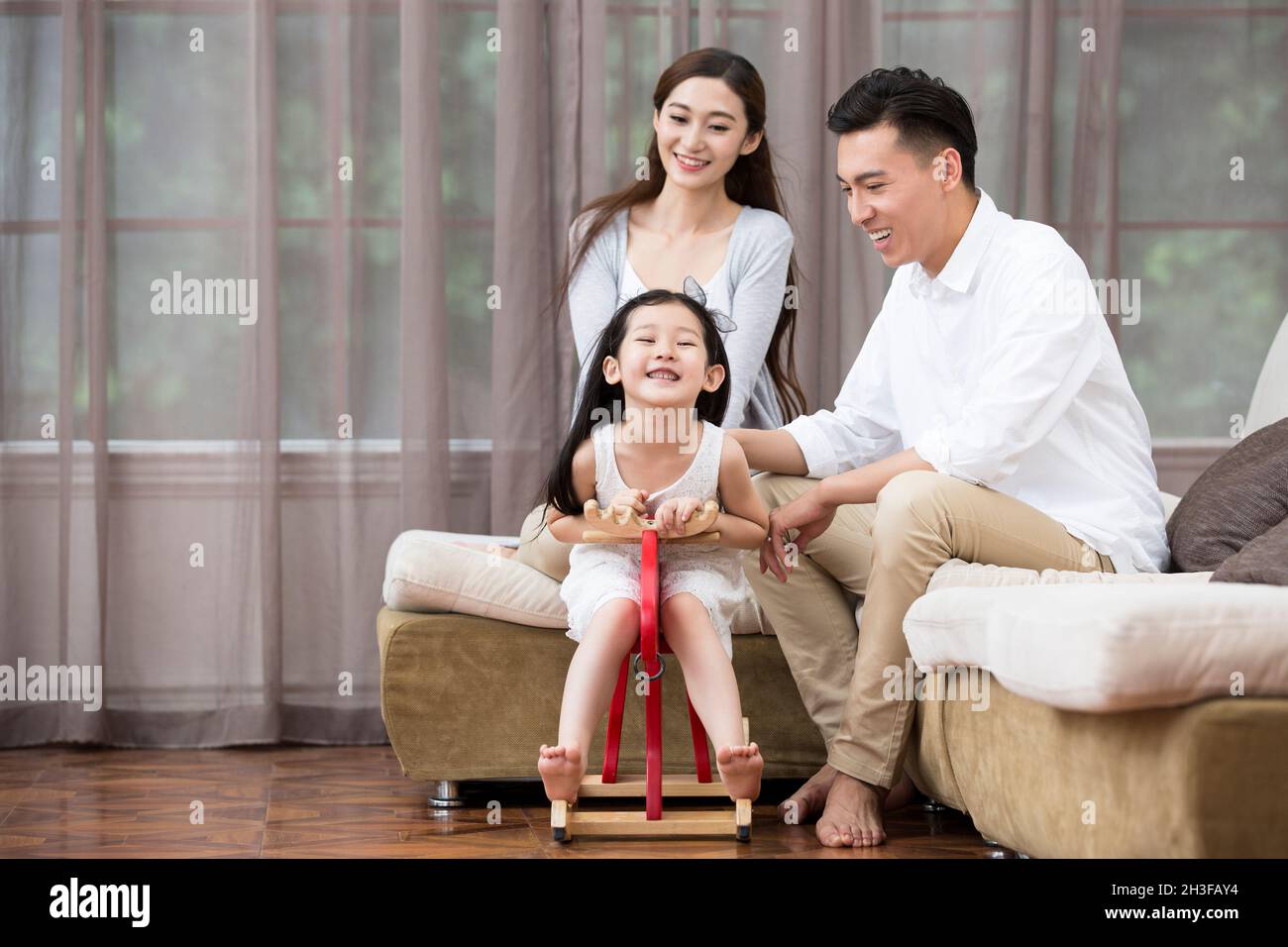 Warm and loving family of three Stock Photo - Alamy