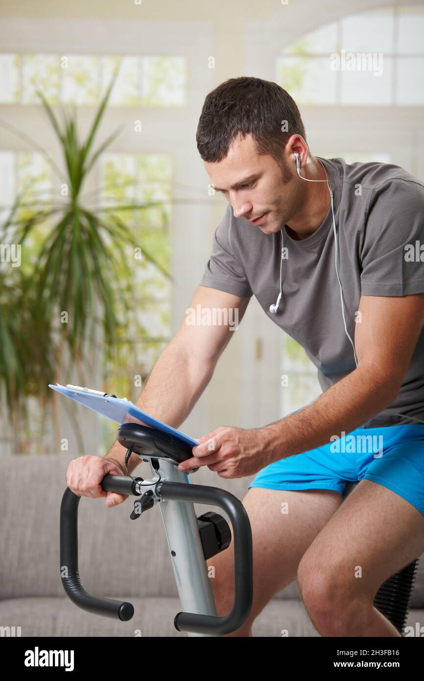 Man training on stationary bike Stock Photo - Alamy