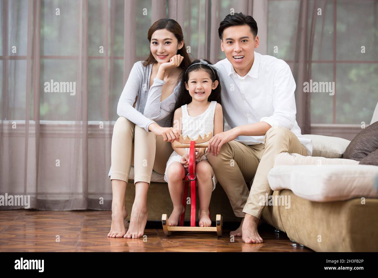 Warm and loving family of three Stock Photo - Alamy