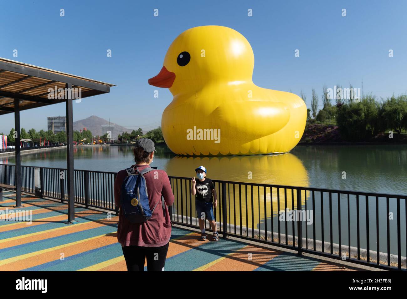 Santiago, Metropolitana, Chile. 28th Oct, 2021. A mother photographs ...