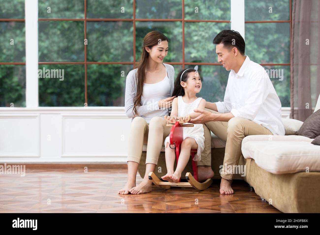 Warm and loving family of three Stock Photo - Alamy
