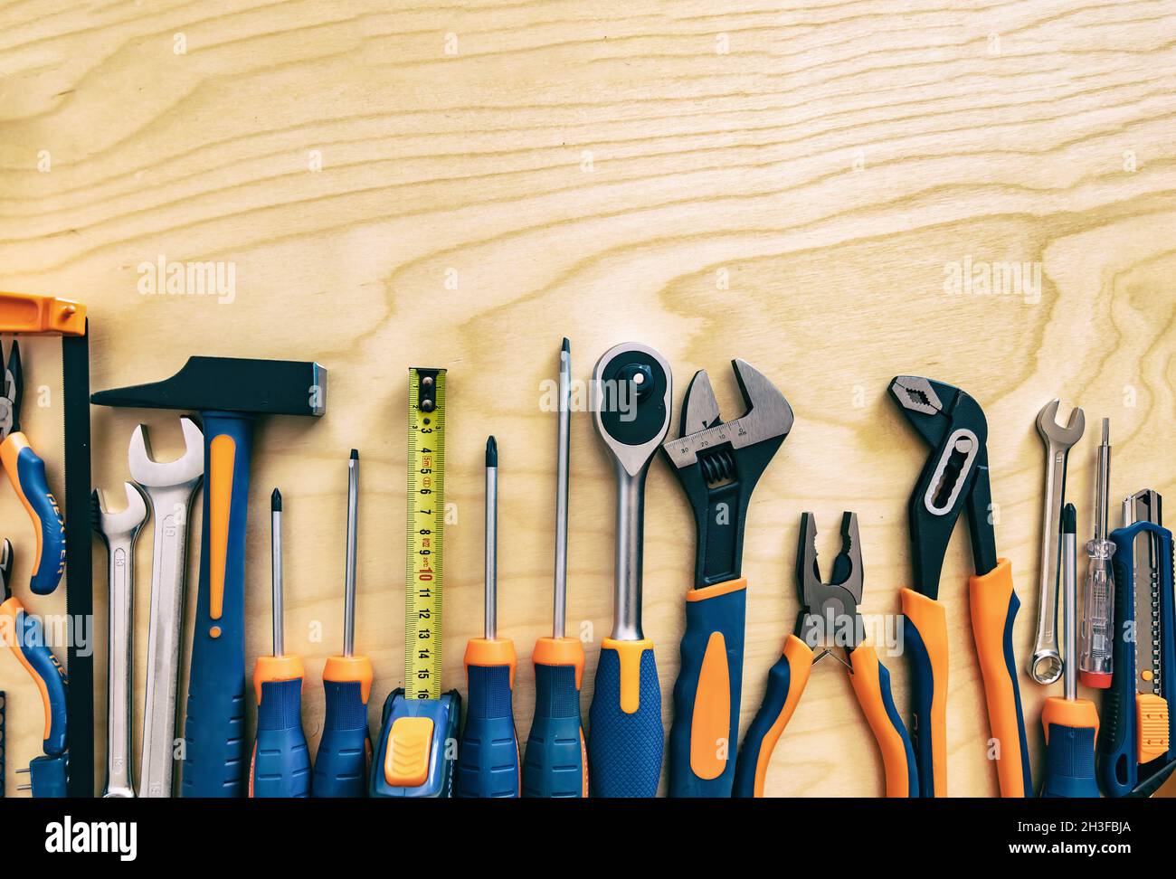 Home repair tools set on wooden background. DIY, maintenance service ...