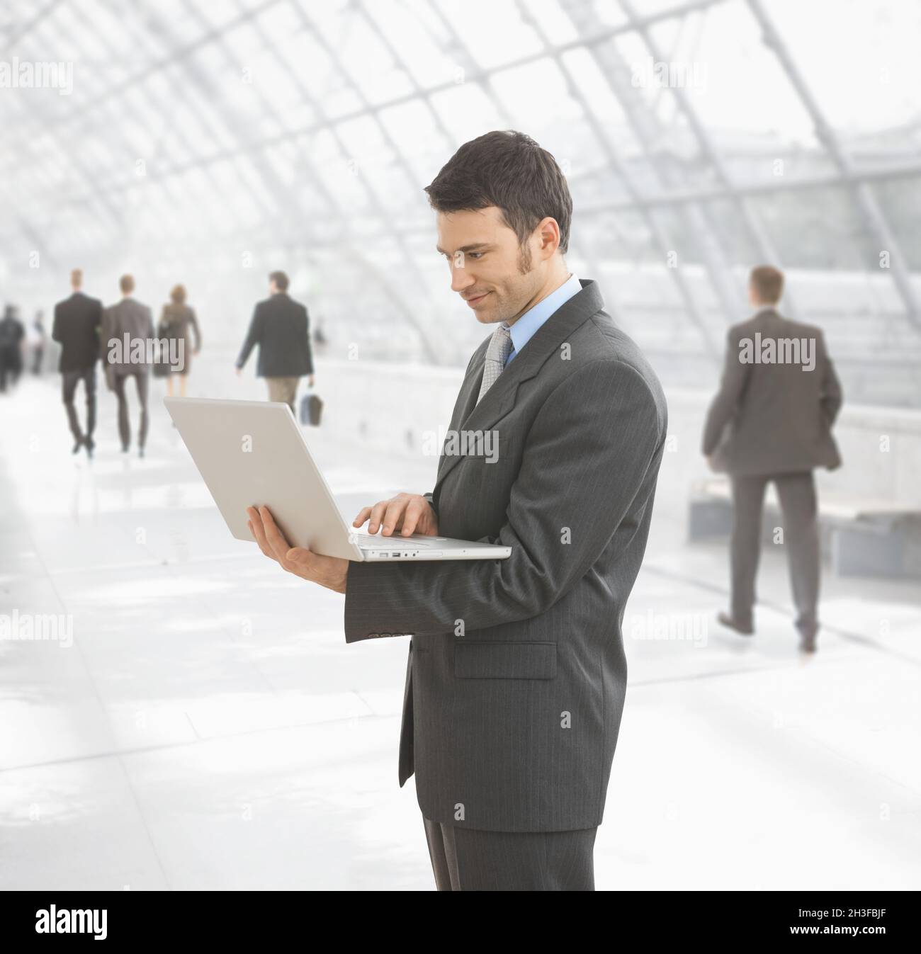 Businessman using laptop computer Stock Photo - Alamy