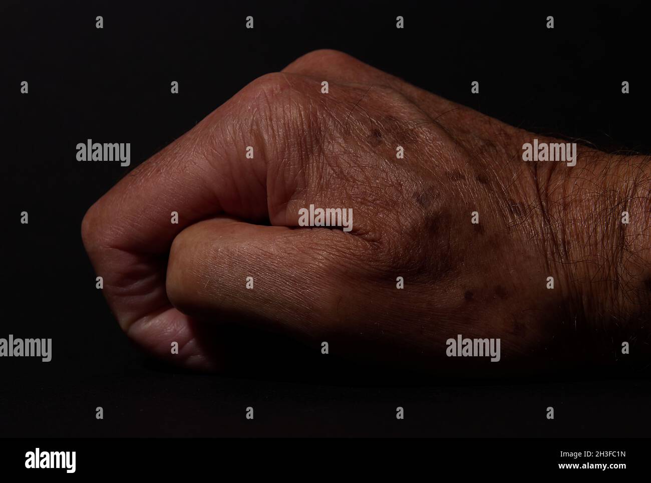 Mature mans hands resting Stock Photo - Alamy