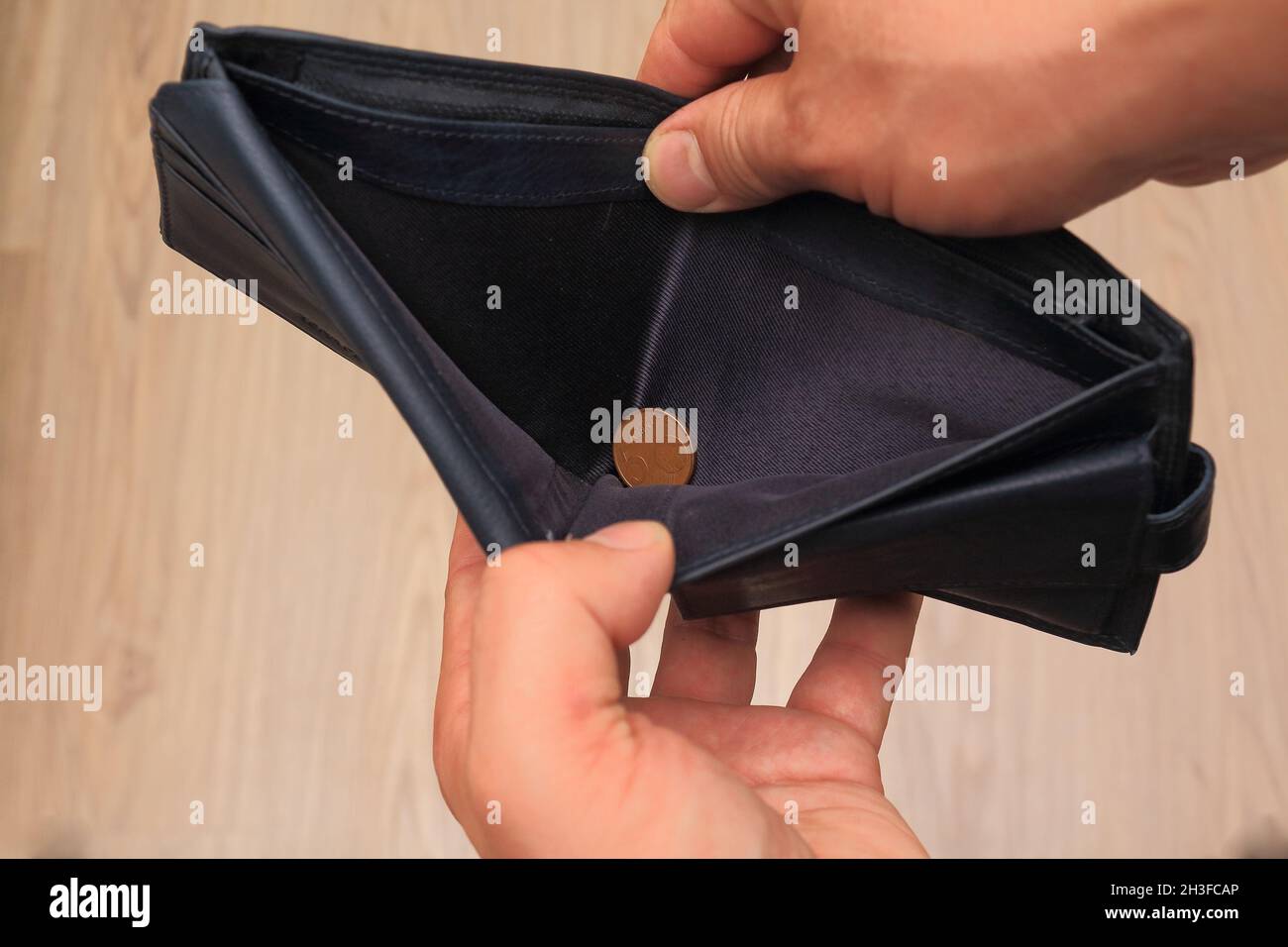Poor man hand open wallet with five euro cent coin looking for money ...