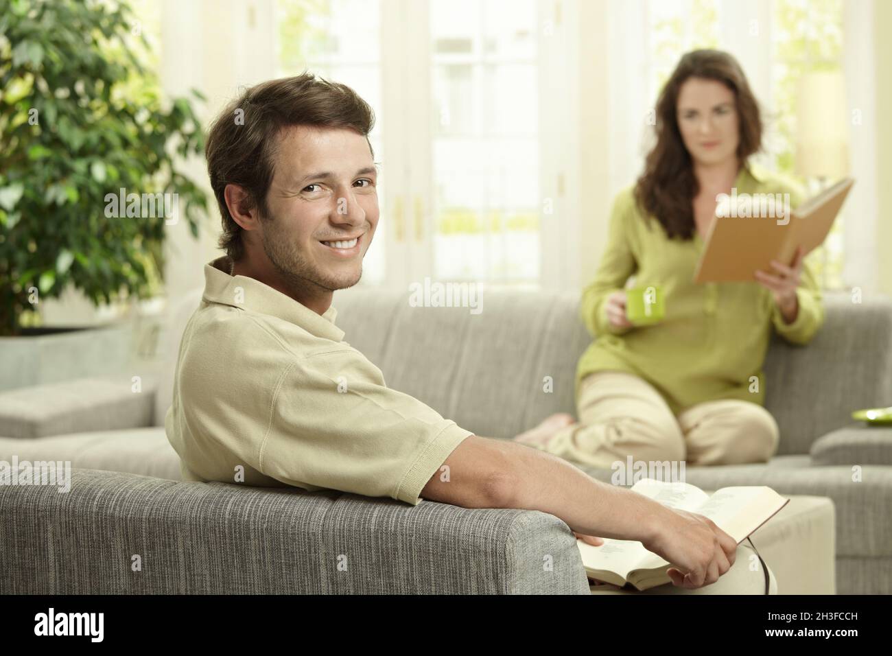 Couple reading book Stock Photo - Alamy