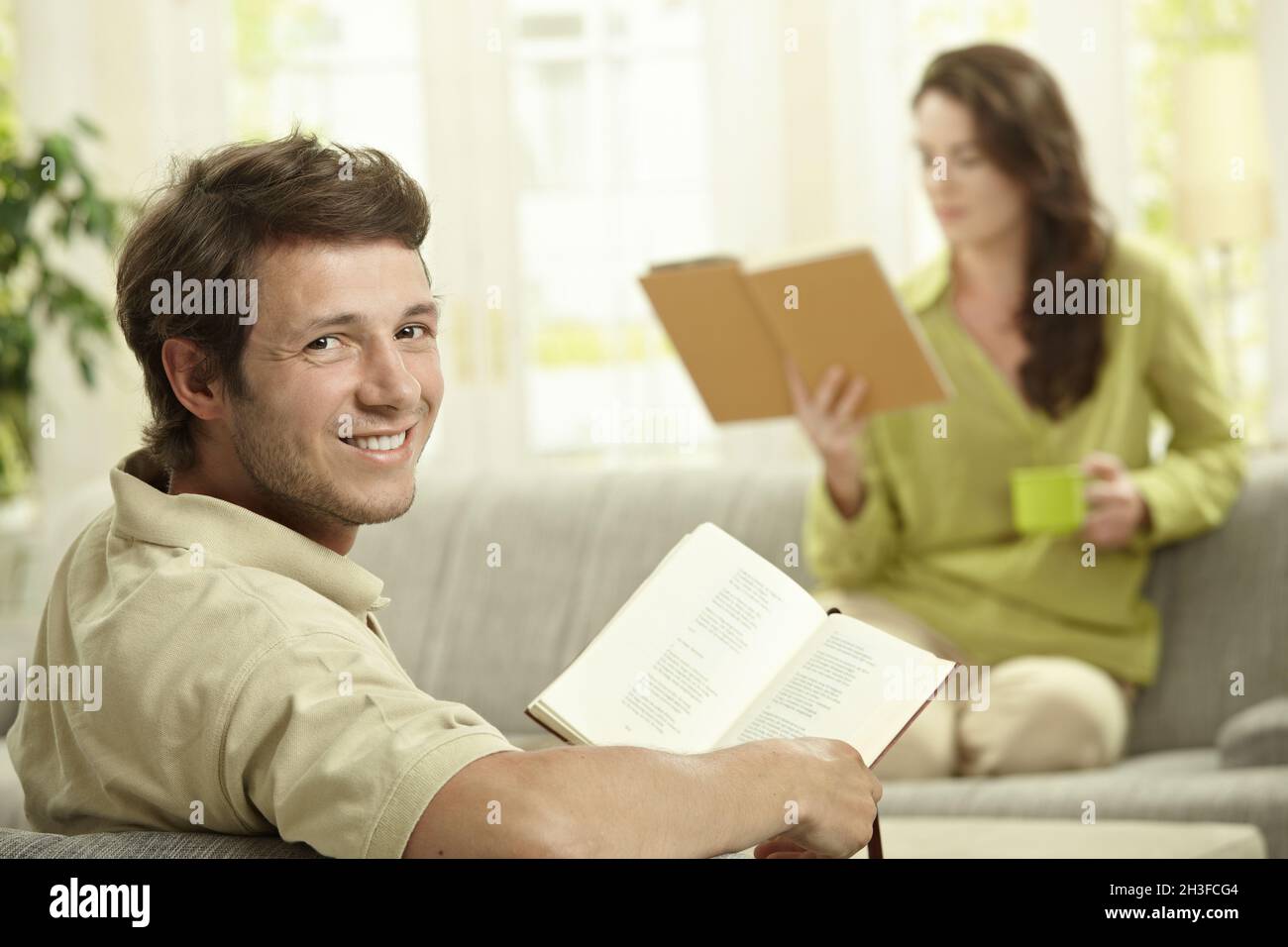 Couple reading book Stock Photo - Alamy