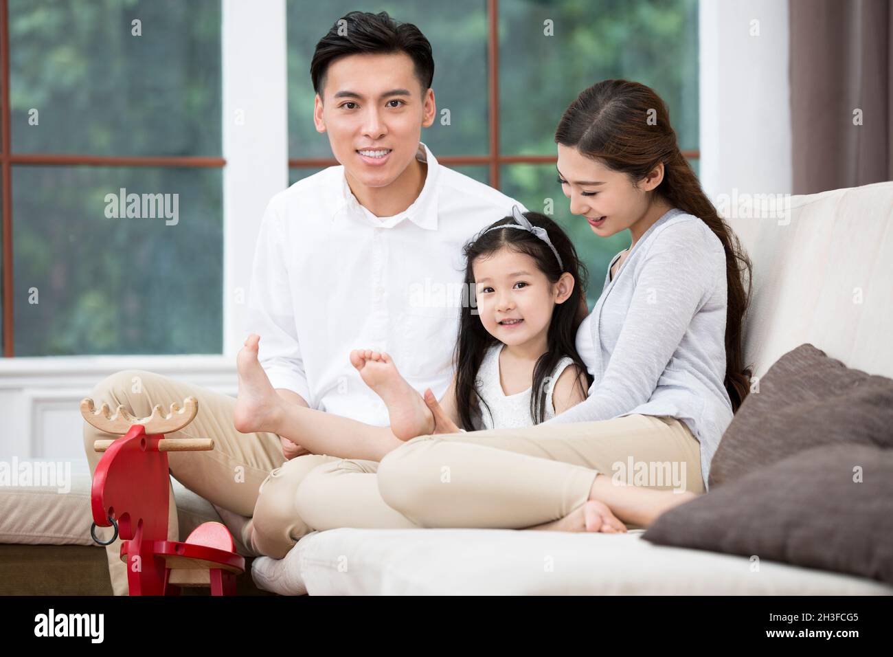 Warm and loving family of three Stock Photo - Alamy