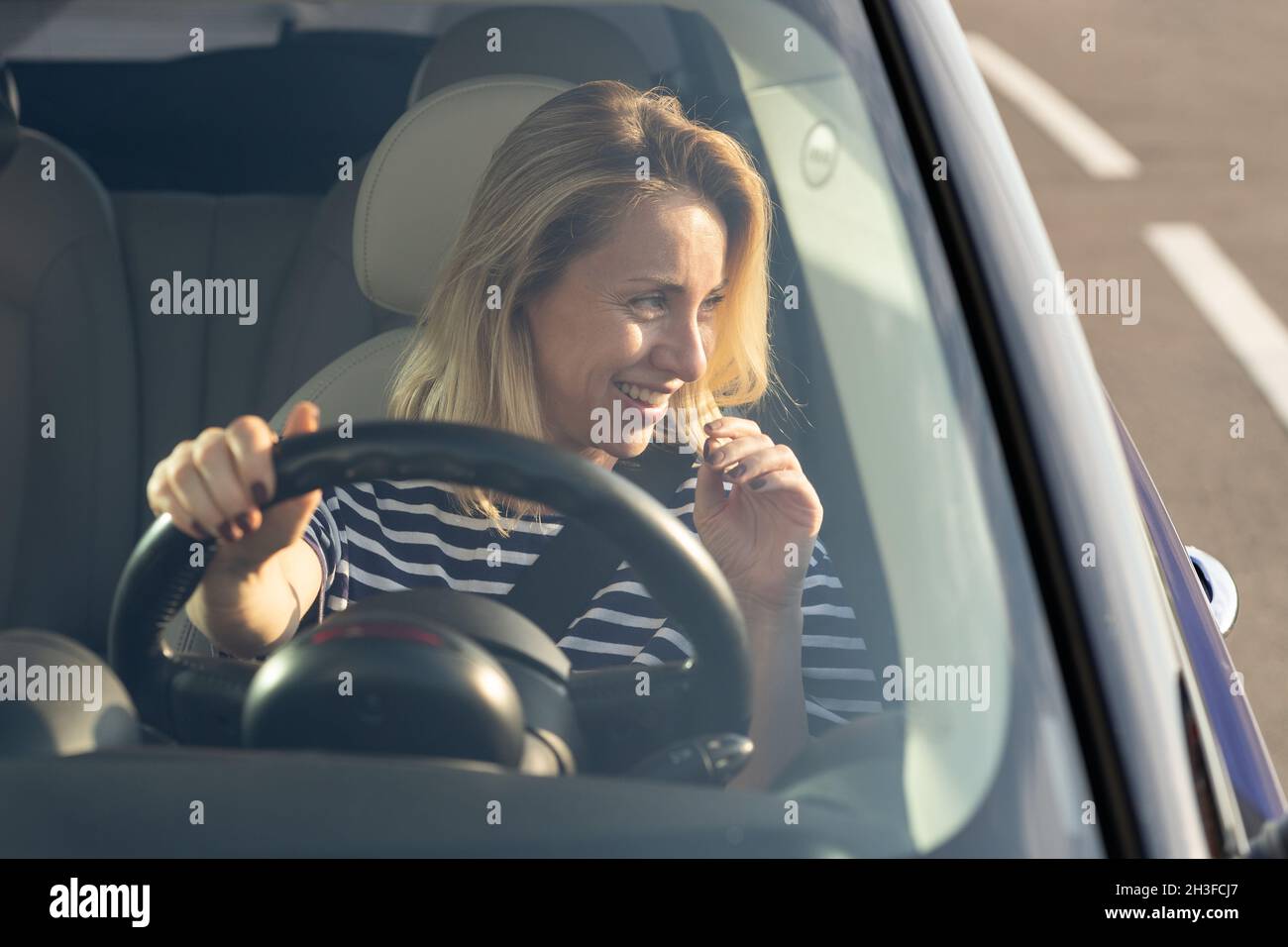 Female in car. Experienced confident woman driver holding steering ...