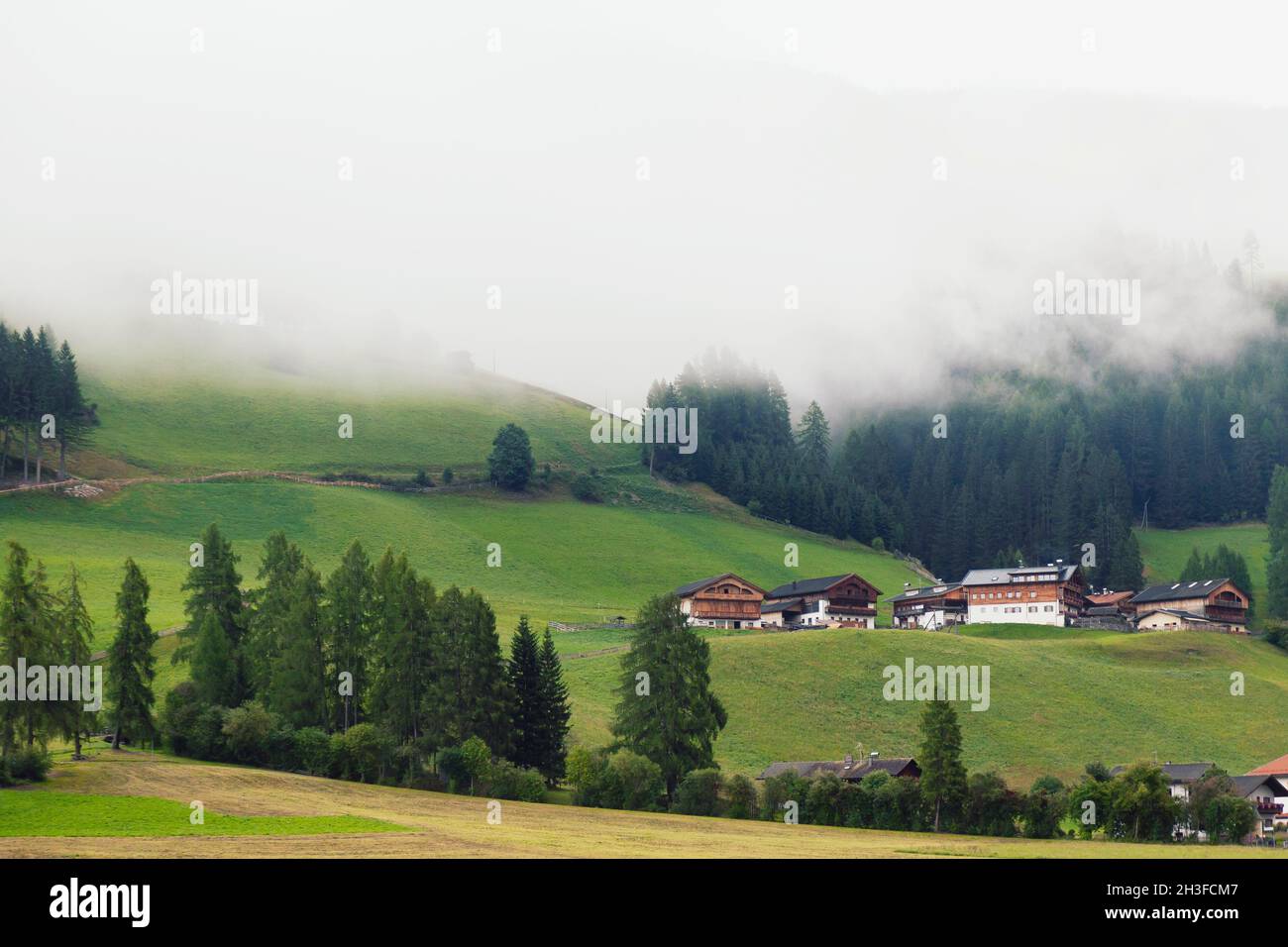 Small village in the Austrian Alps in early foggy morning, scenic ...