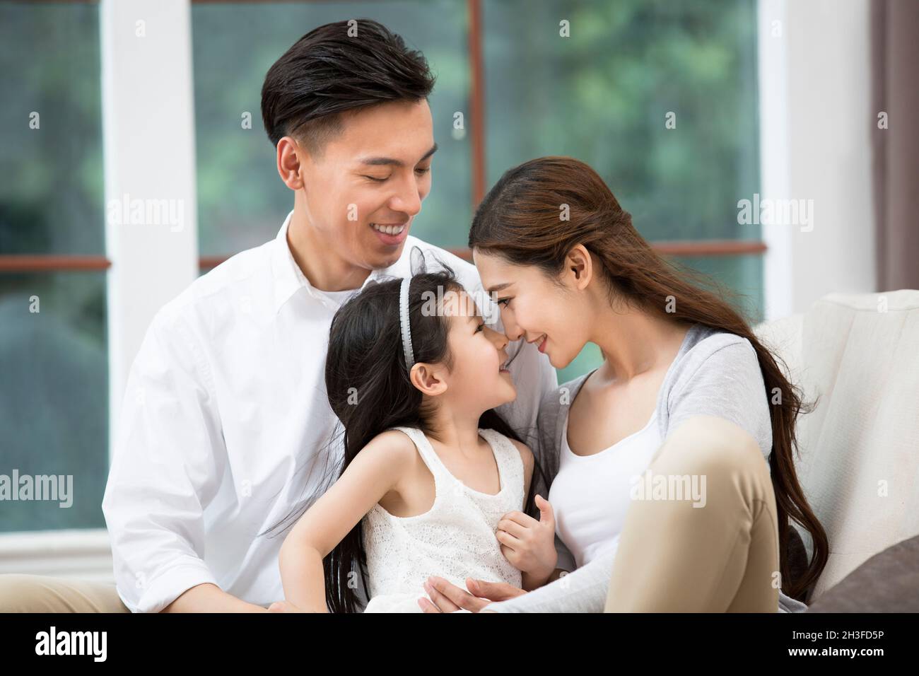 Warm and loving family of three Stock Photo - Alamy