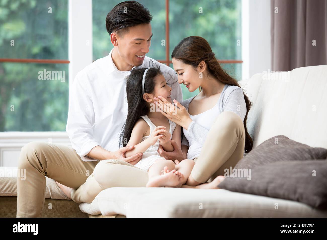 Warm and loving family of three Stock Photo - Alamy