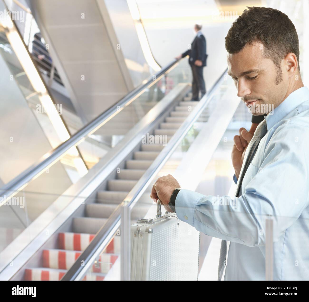 Mid adult businessman checking hi-res stock photography and images - Alamy