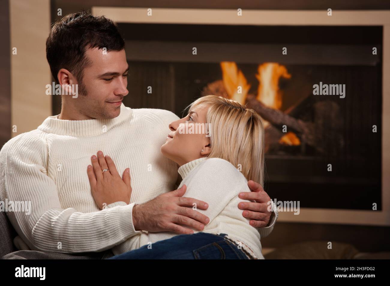 Couple hugging home Stock Photo - Alamy