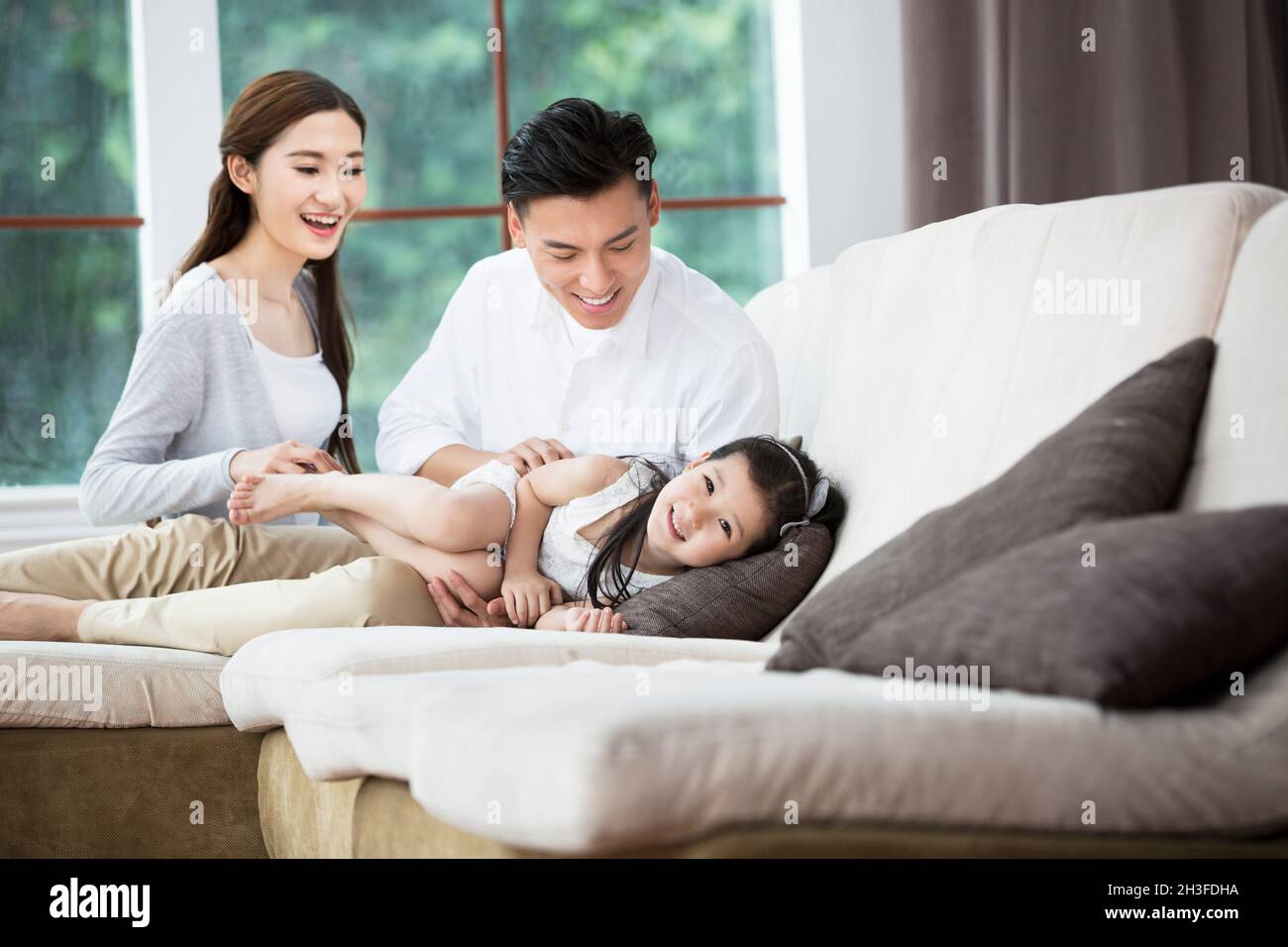 Warm and loving family of three Stock Photo - Alamy