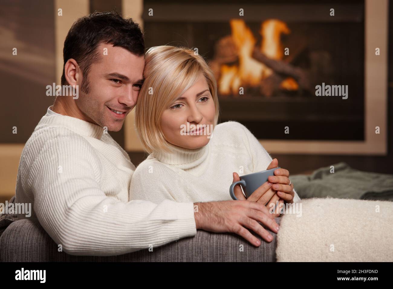 Couple hugging home Stock Photo - Alamy