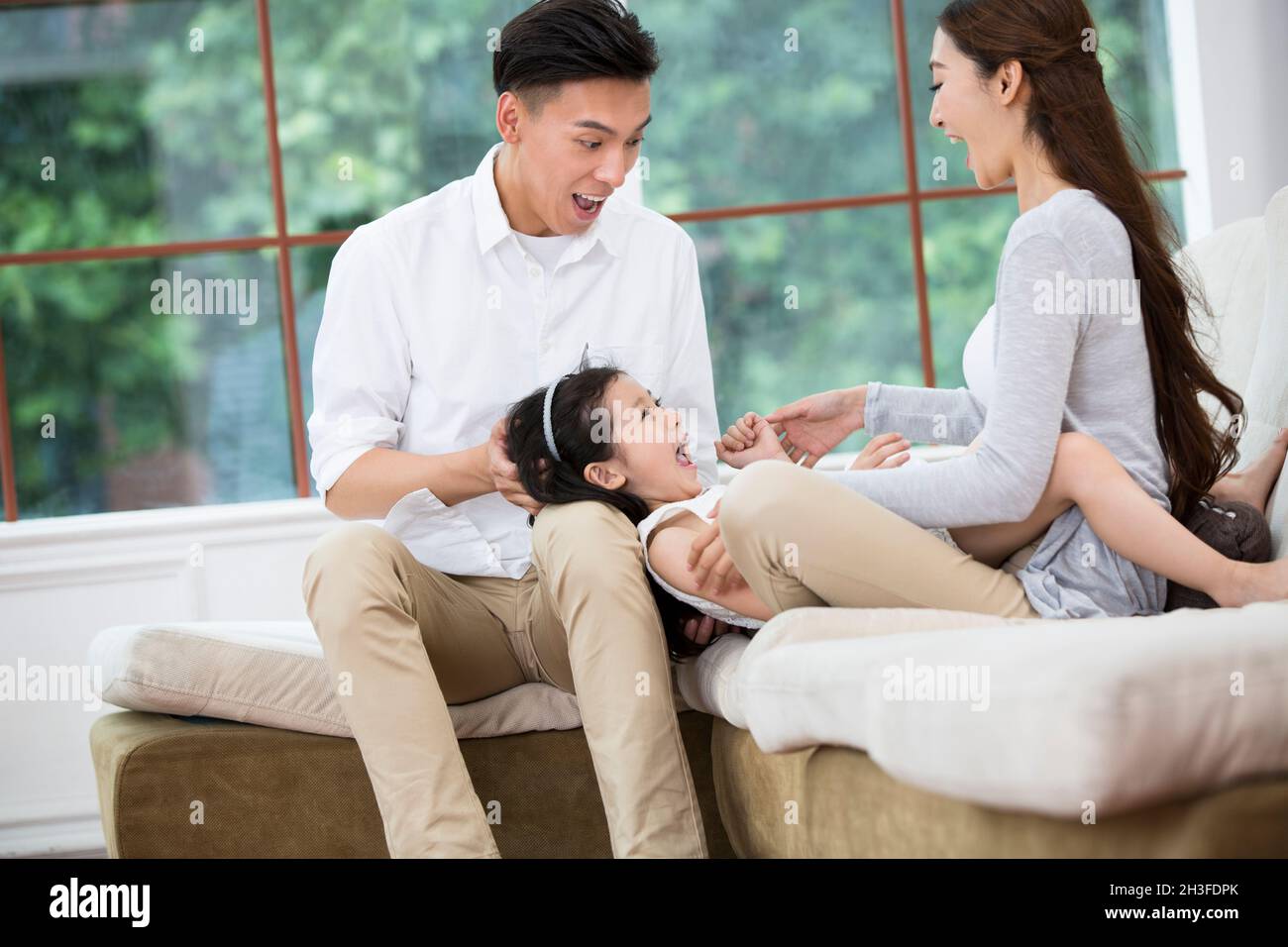 Warm and loving family of three Stock Photo - Alamy