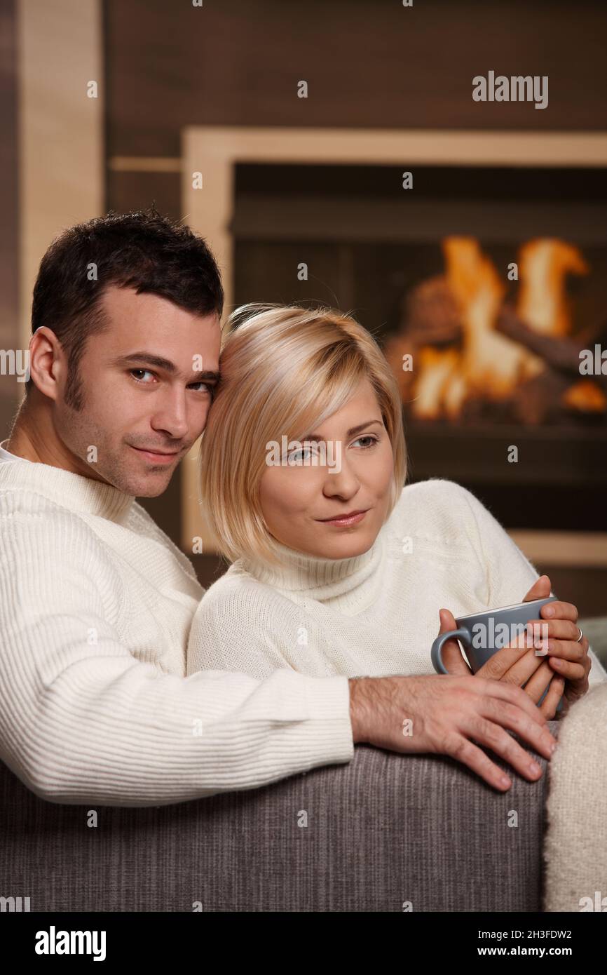Couple hugging home Stock Photo - Alamy
