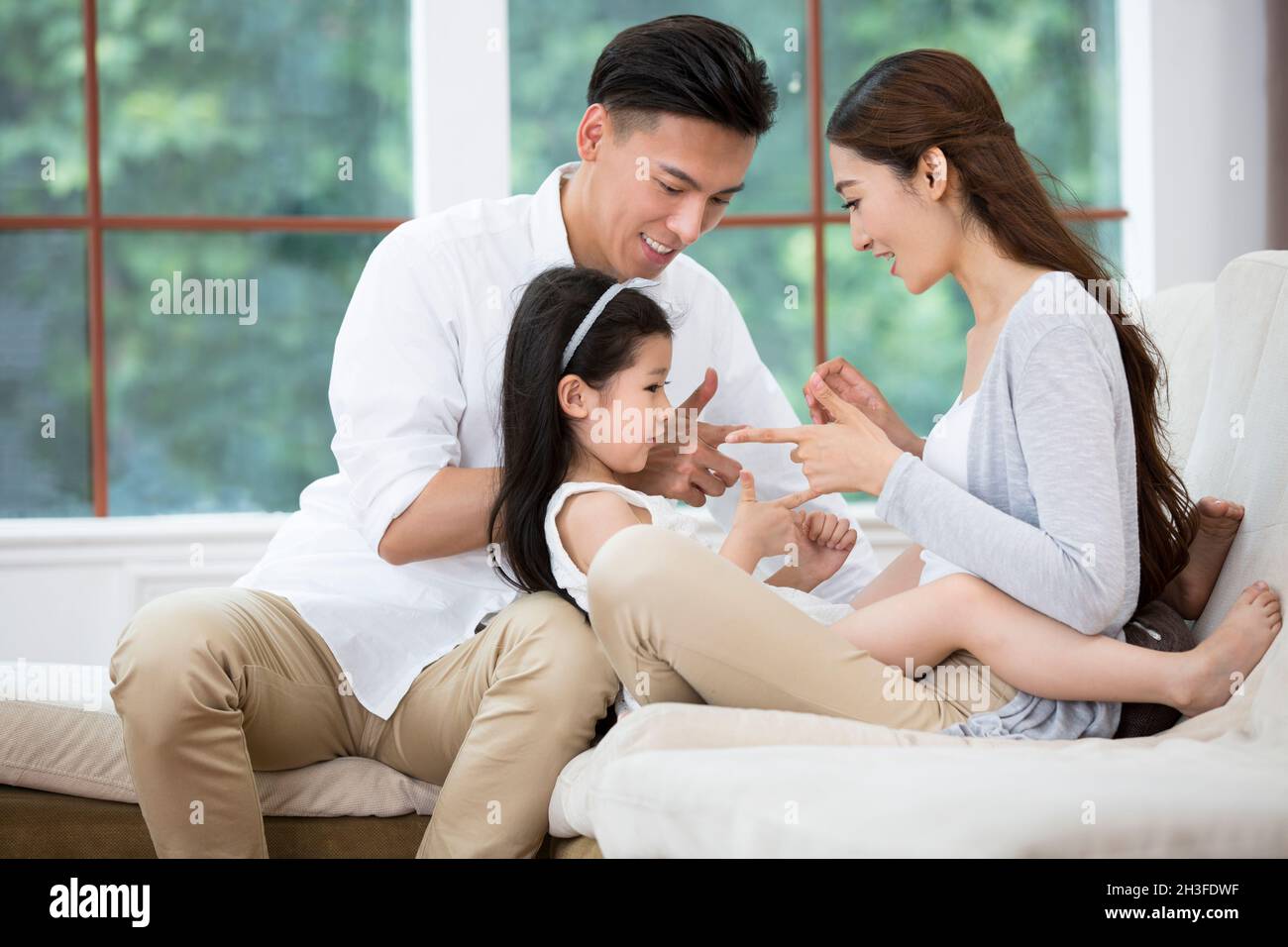 Warm and loving family of three Stock Photo - Alamy