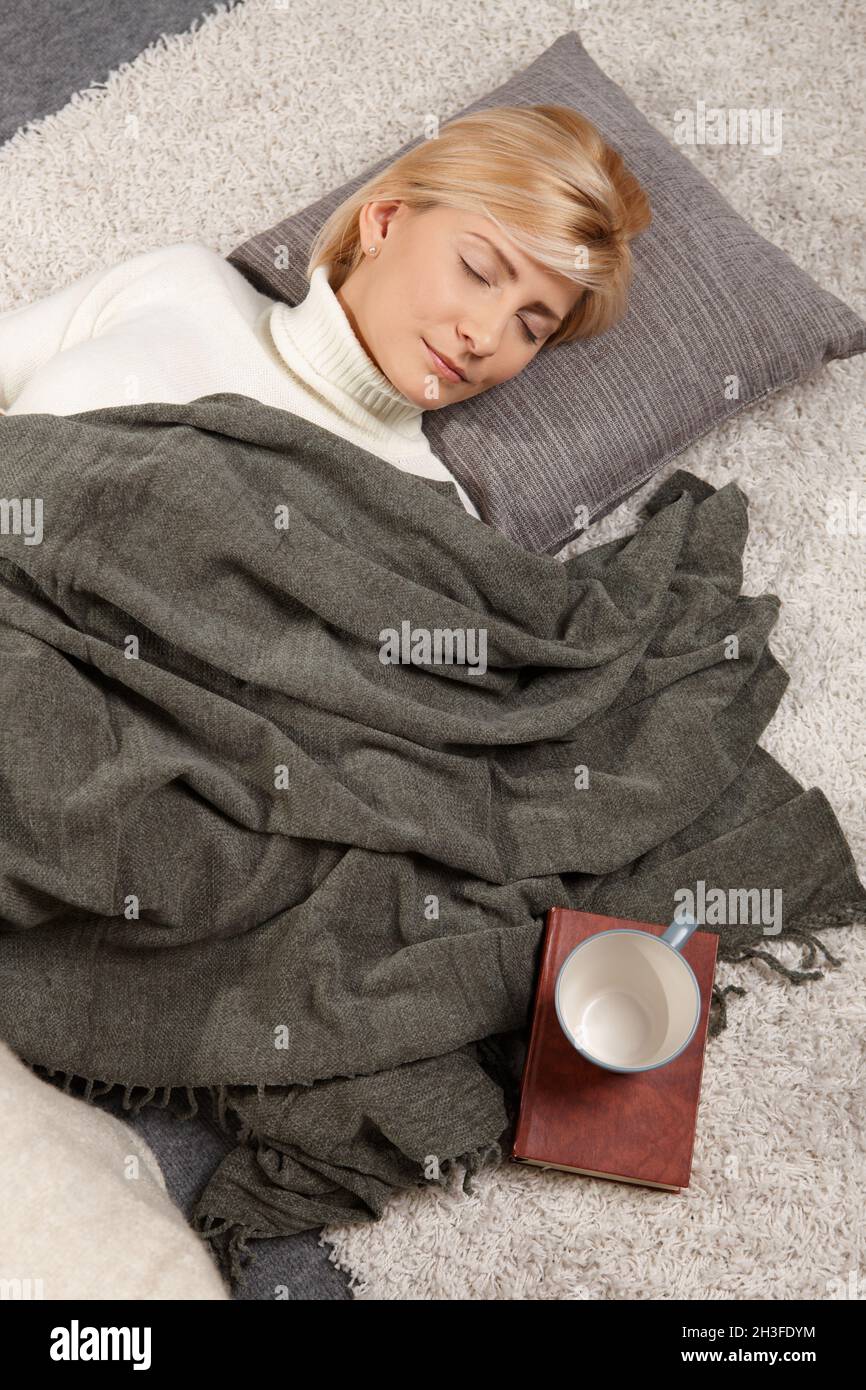 Woman sleeping on floor Stock Photo - Alamy