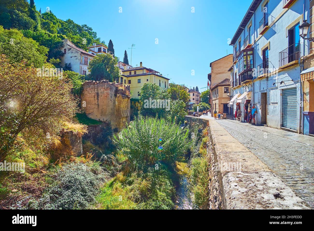 The small Darro River, medieval Carrera del Darro street and the brick ...