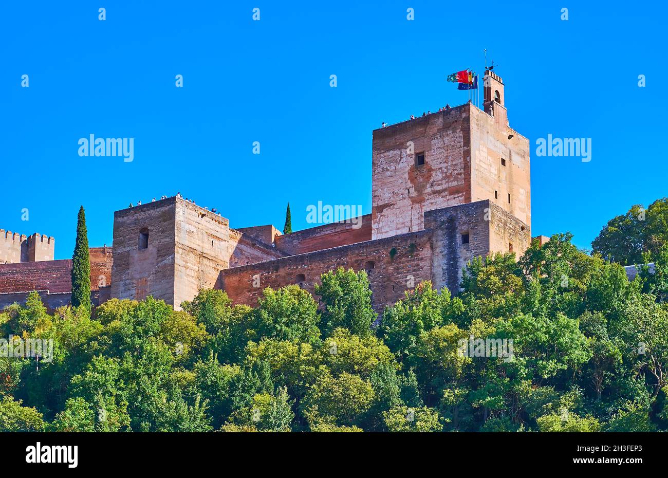 The tall towers and massive brick ramparts of Alcazaba of Alhambra ...