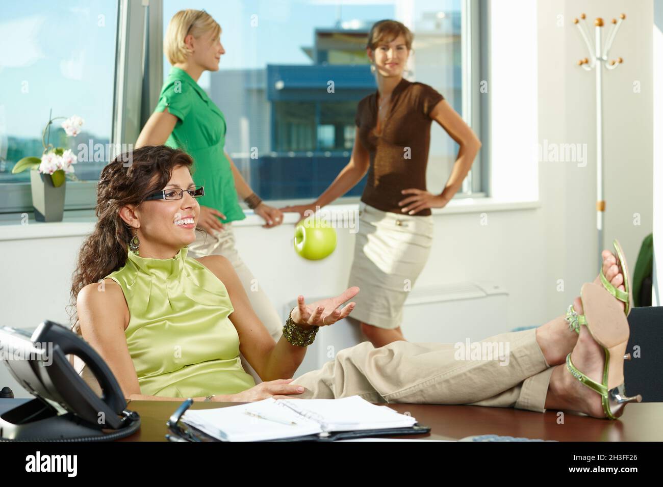Businesswoman throwing apple Stock Photo - Alamy