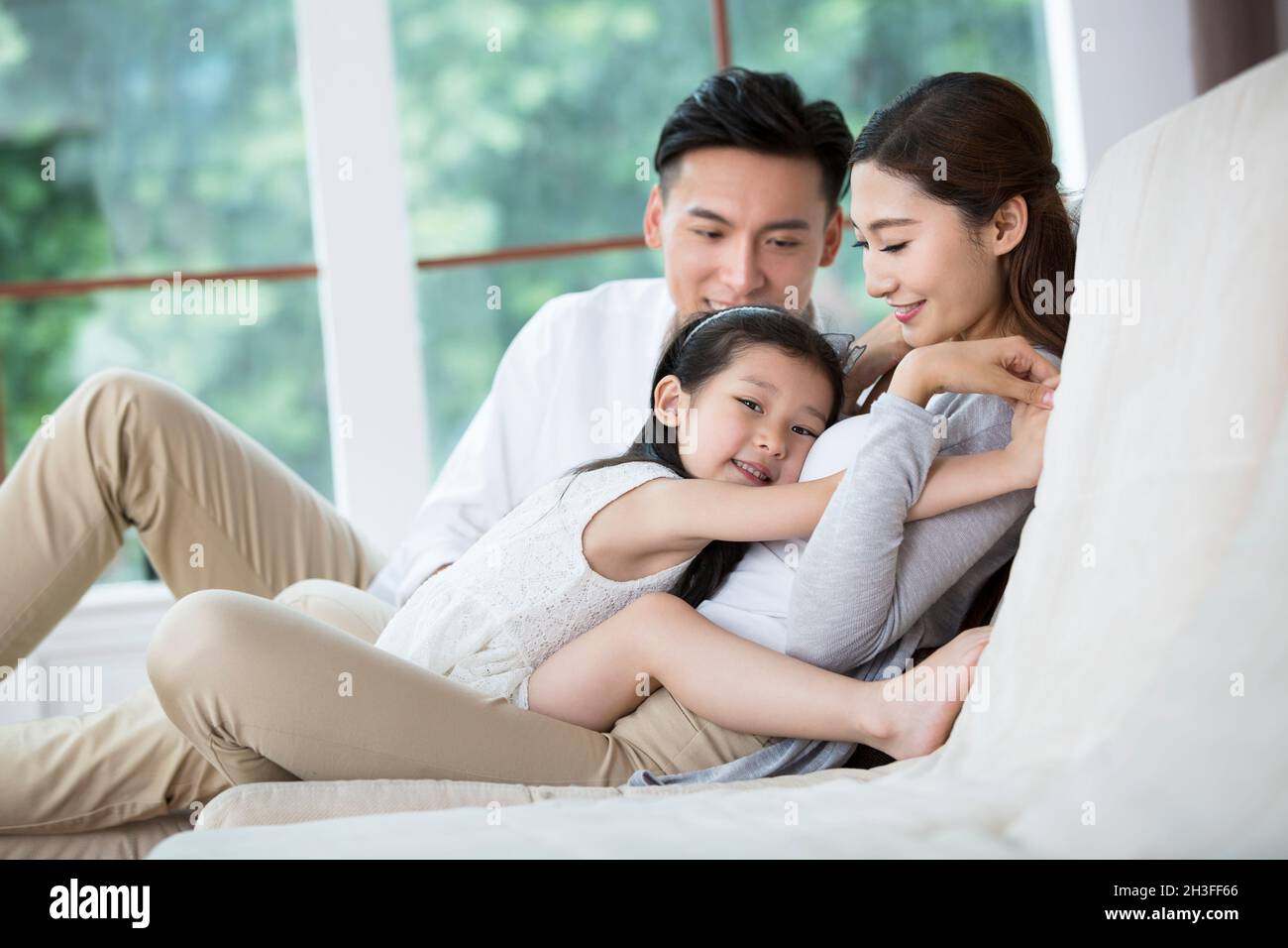 Warm and loving family of three Stock Photo - Alamy