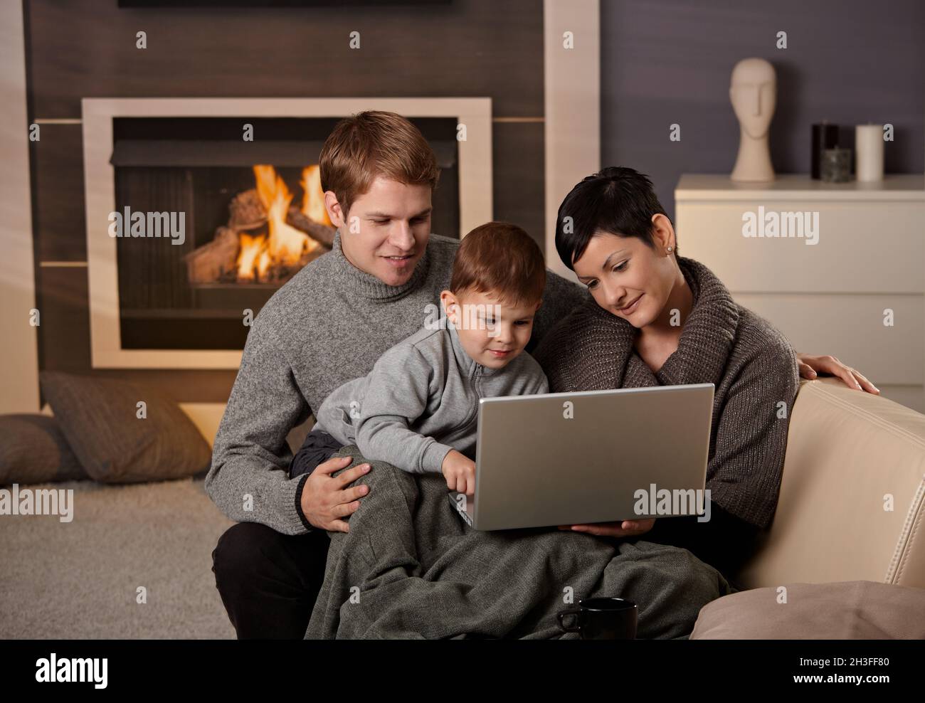 Happy family with computer Stock Photo - Alamy