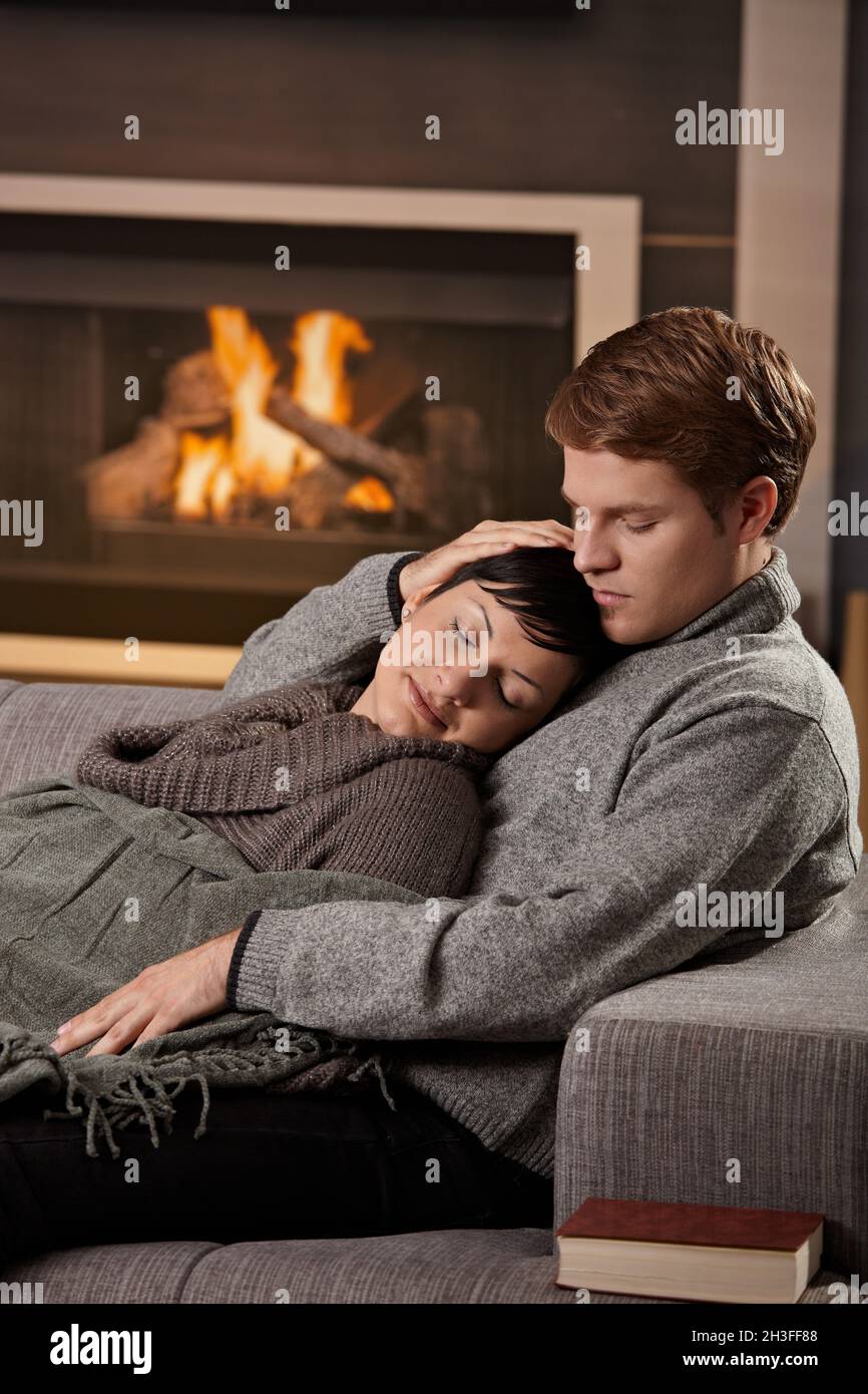 Couple hugging home Stock Photo - Alamy
